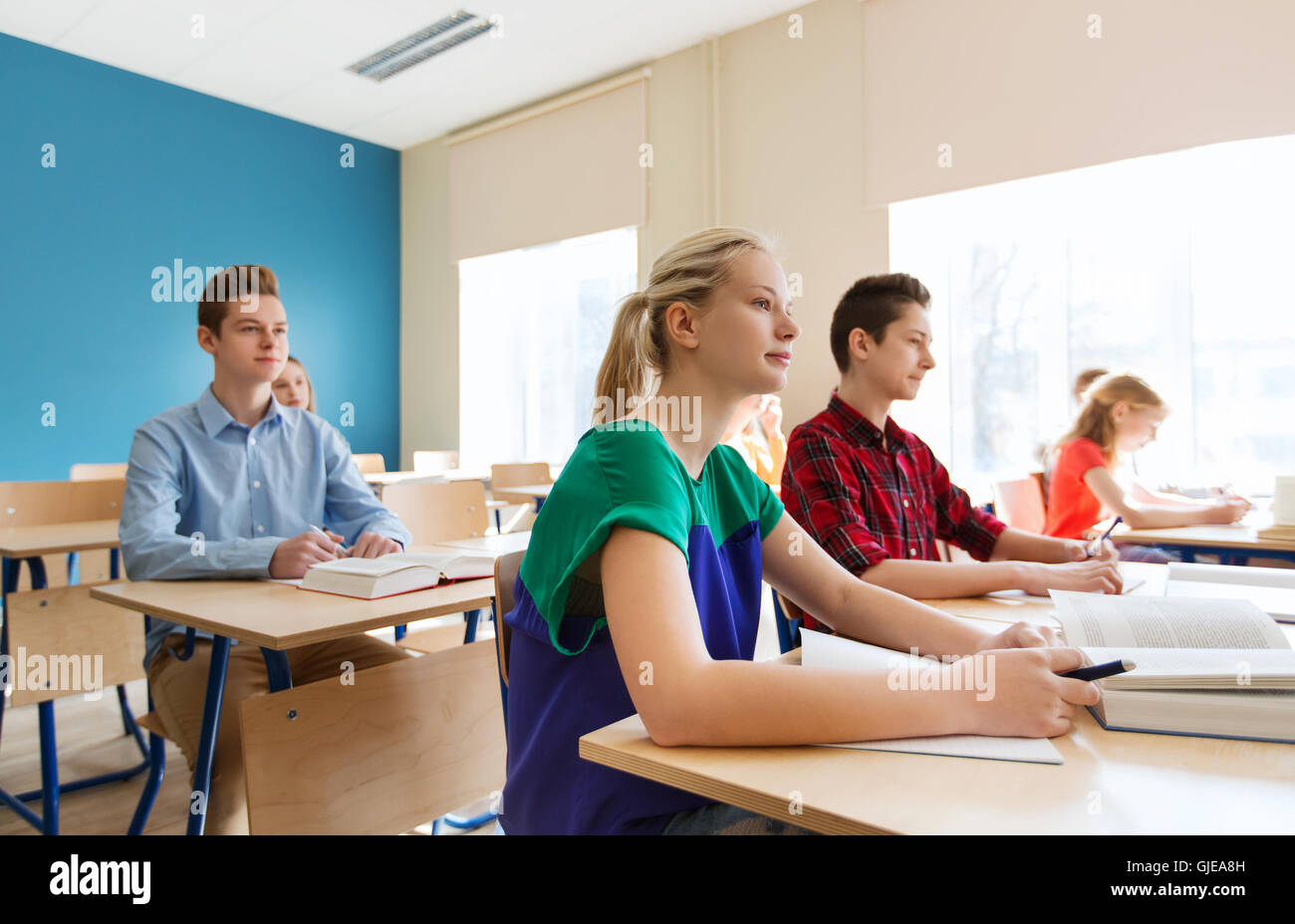 group of students with books at school lesson Stock Photo - Alamy