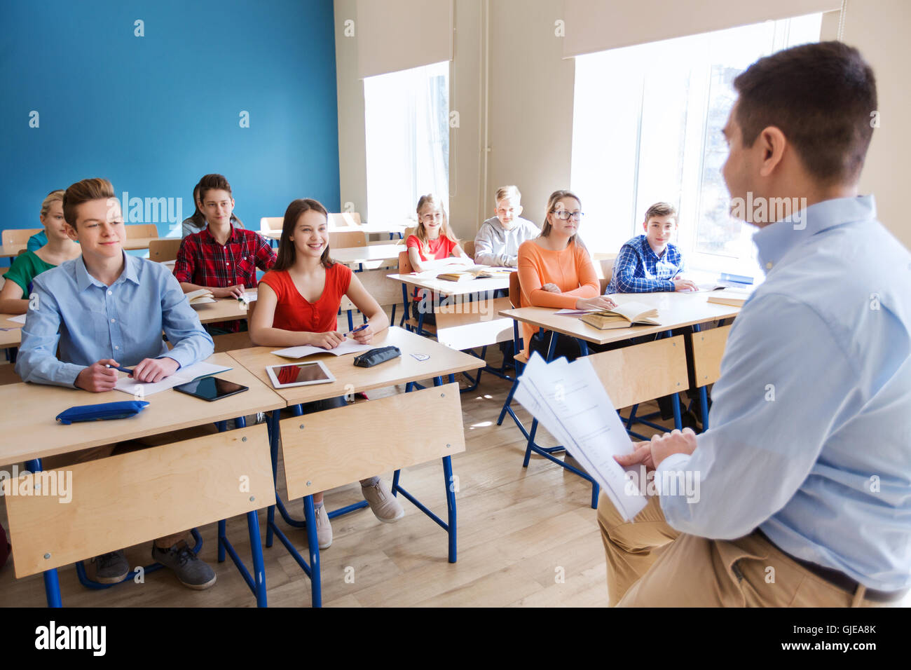 group of students and teacher with papers or tests Stock Photo - Alamy