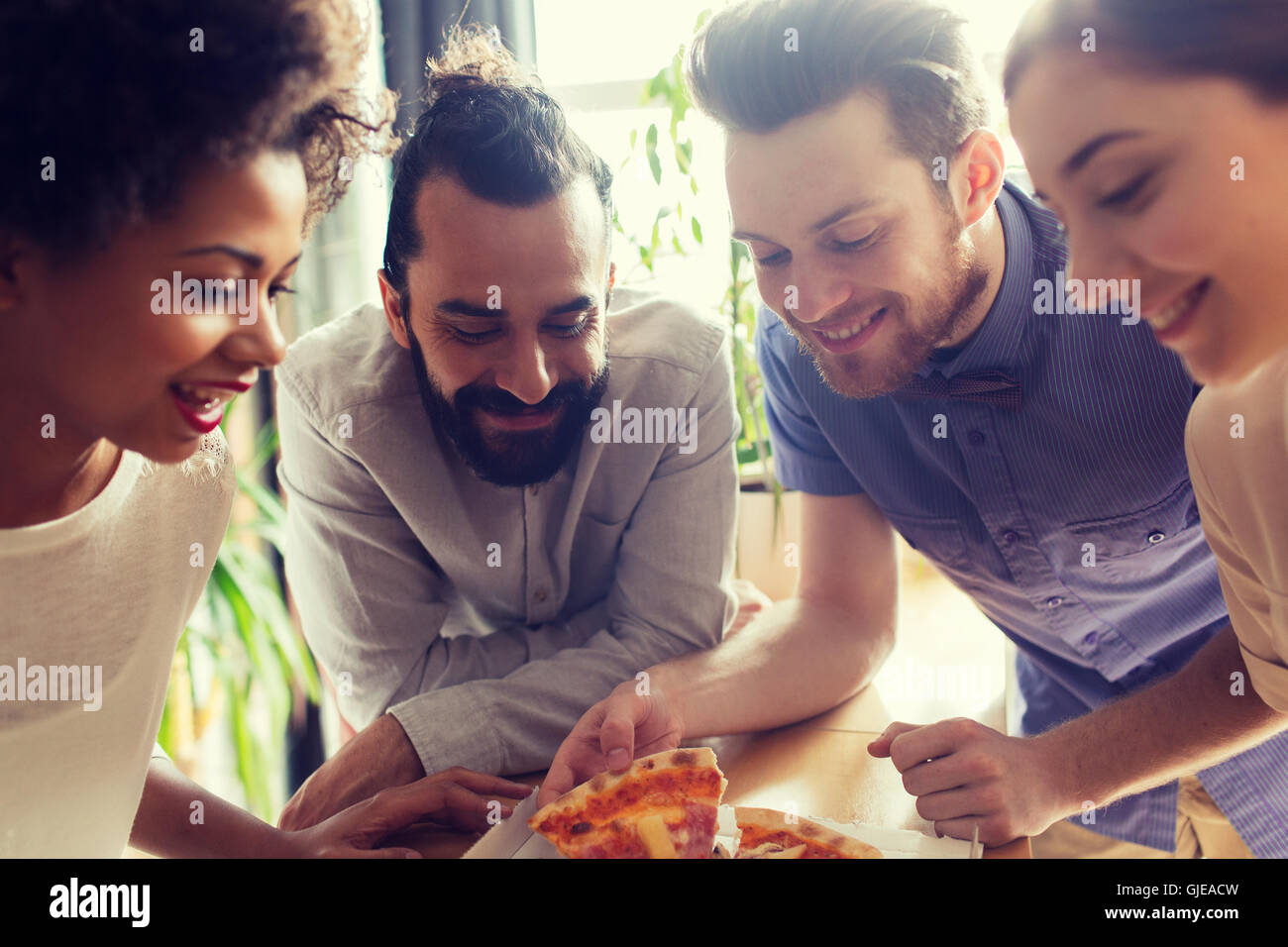 happy business team eating pizza in office Stock Photo - Alamy