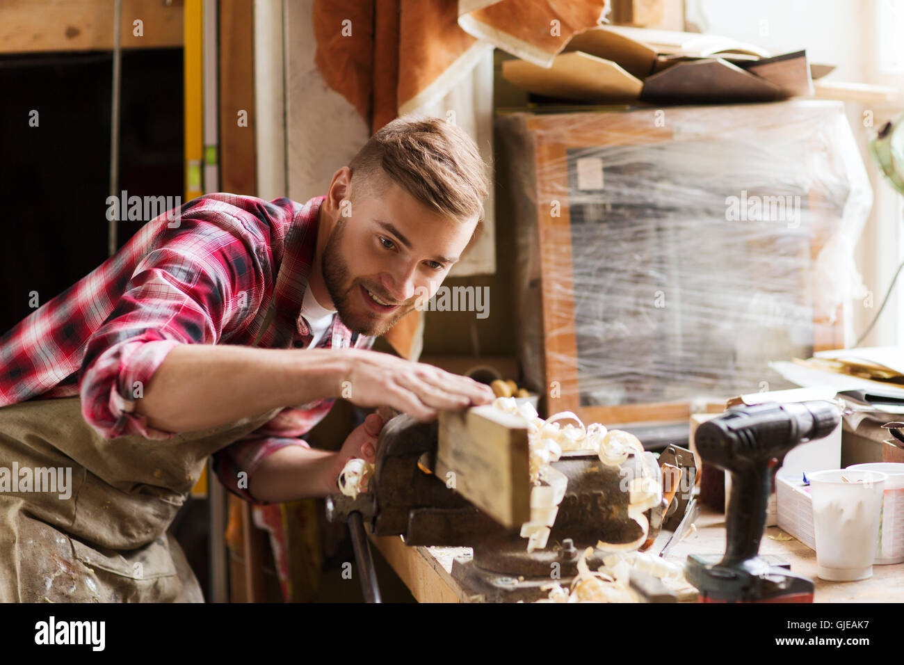 carpenter working with wood plank at workshop Stock Photo - Alamy