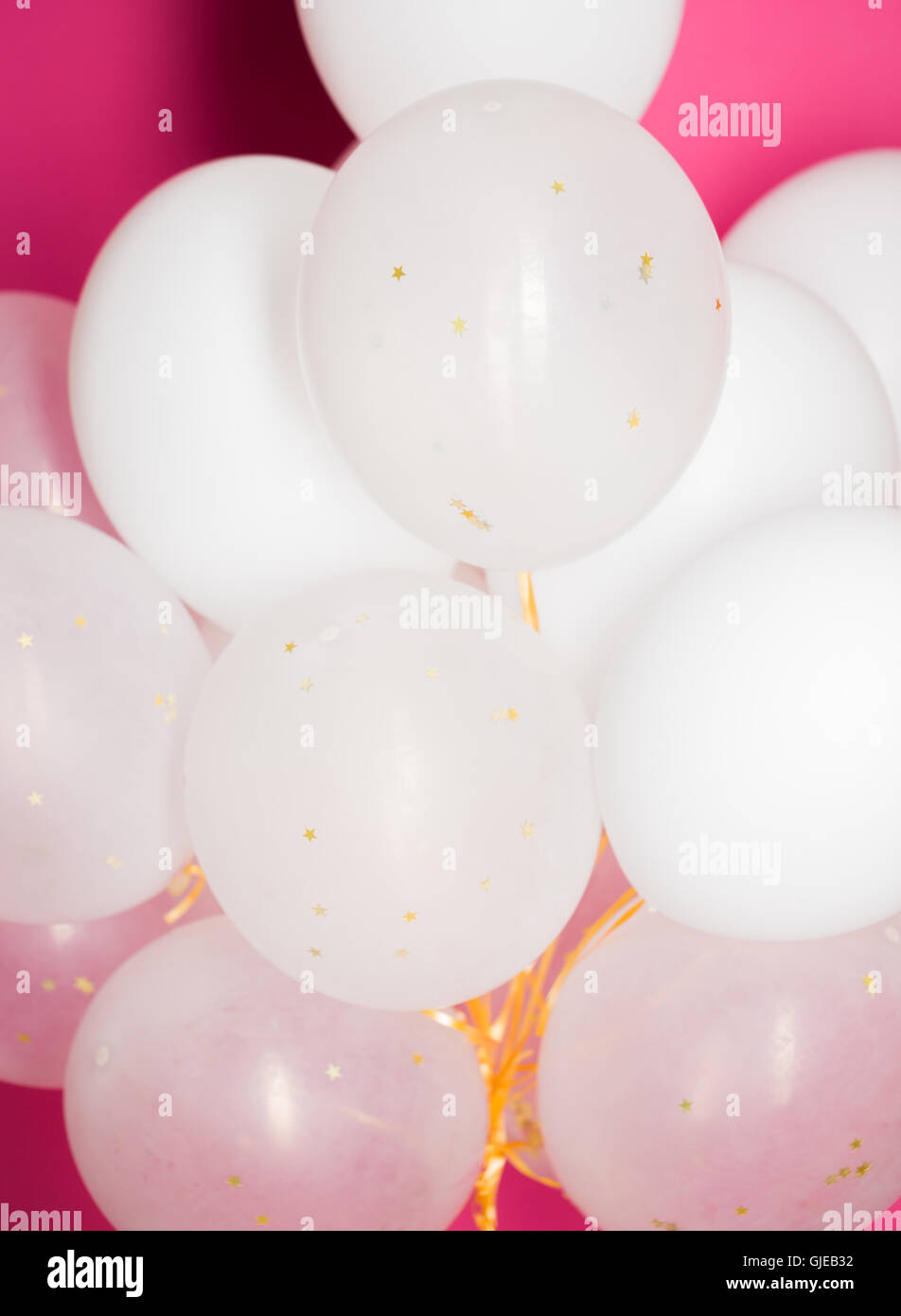 close up of white helium balloons over pink Stock Photo - Alamy