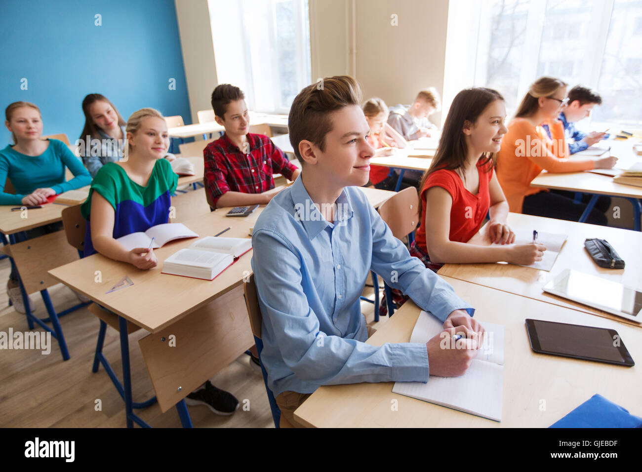 group of students with notebooks at school lesson Stock Photo - Alamy