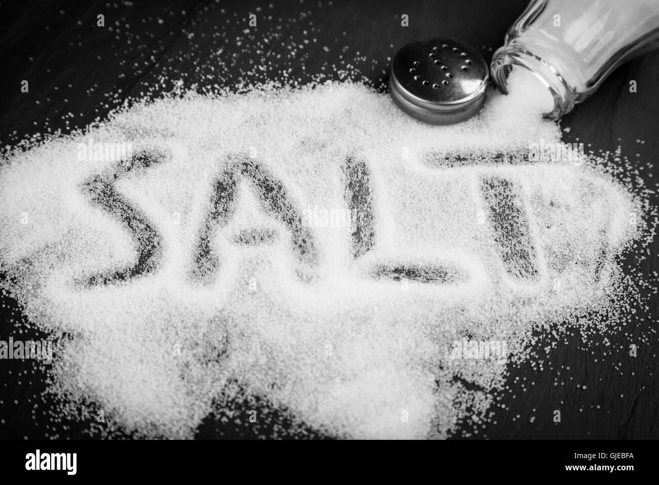 Salt shaker on slate board Stock Photo - Alamy