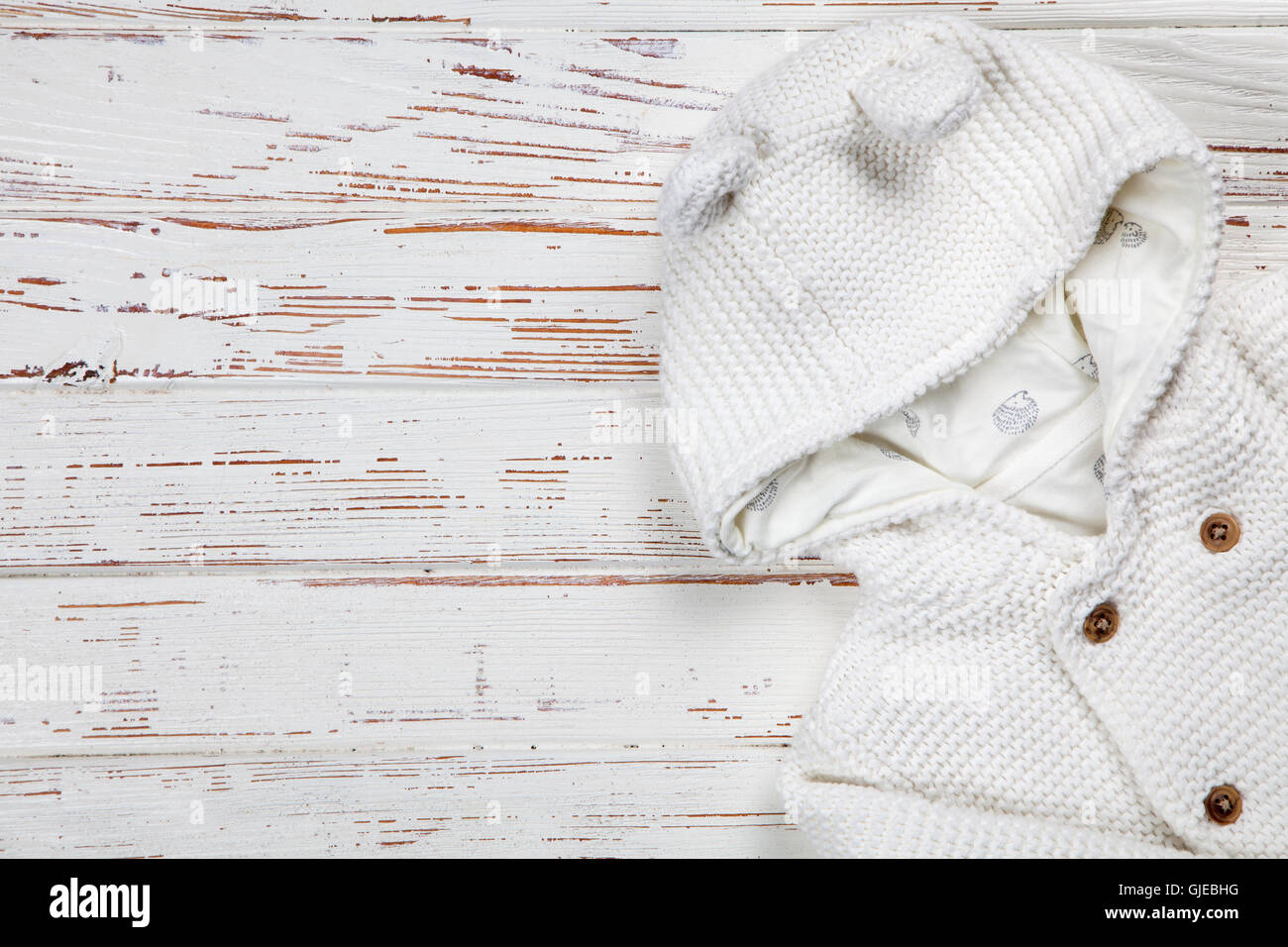 Baby clothes on wooden background Stock Photo - Alamy