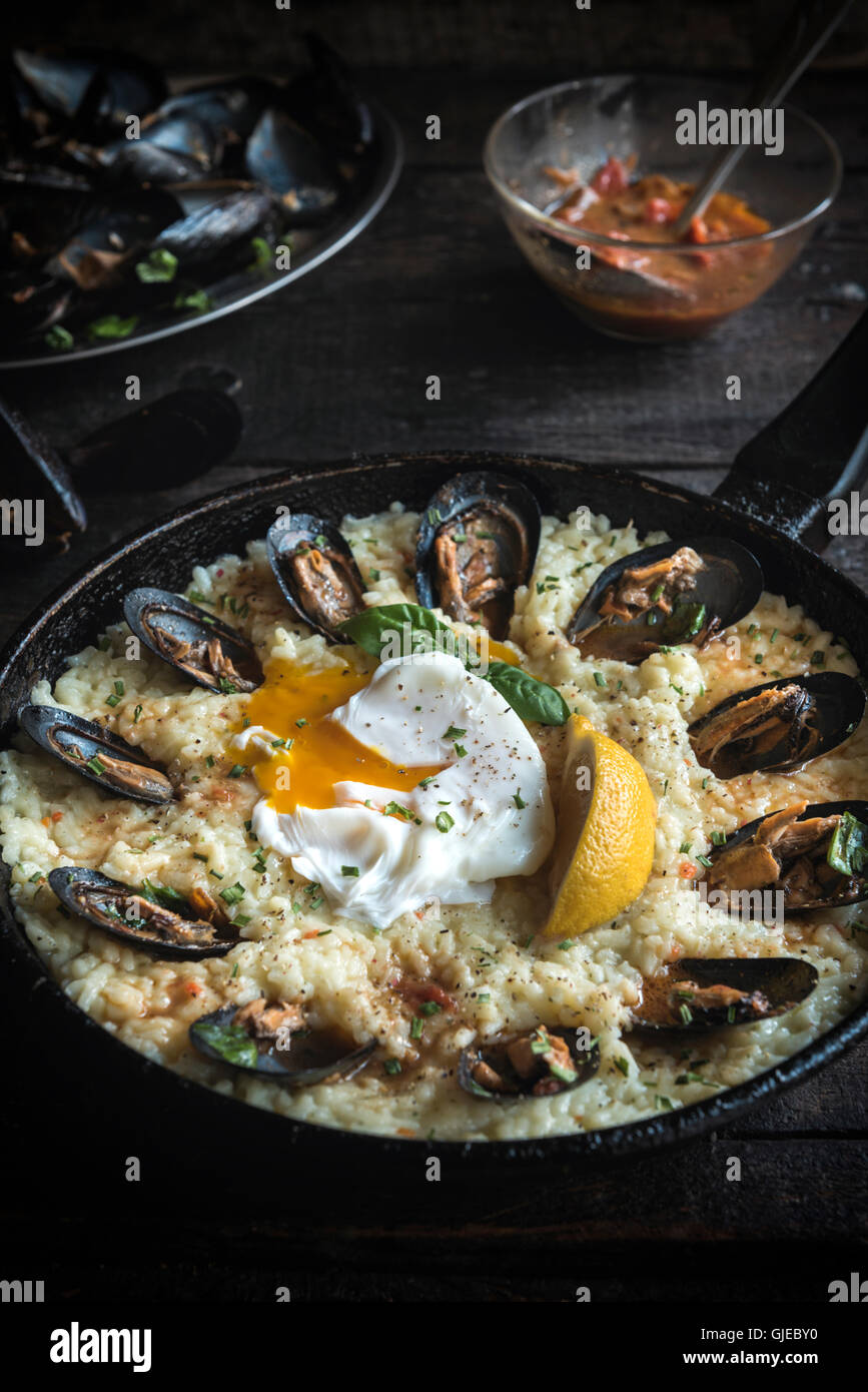 Cooked mussels with boiled egg and spicy rice in the pan,selective ...