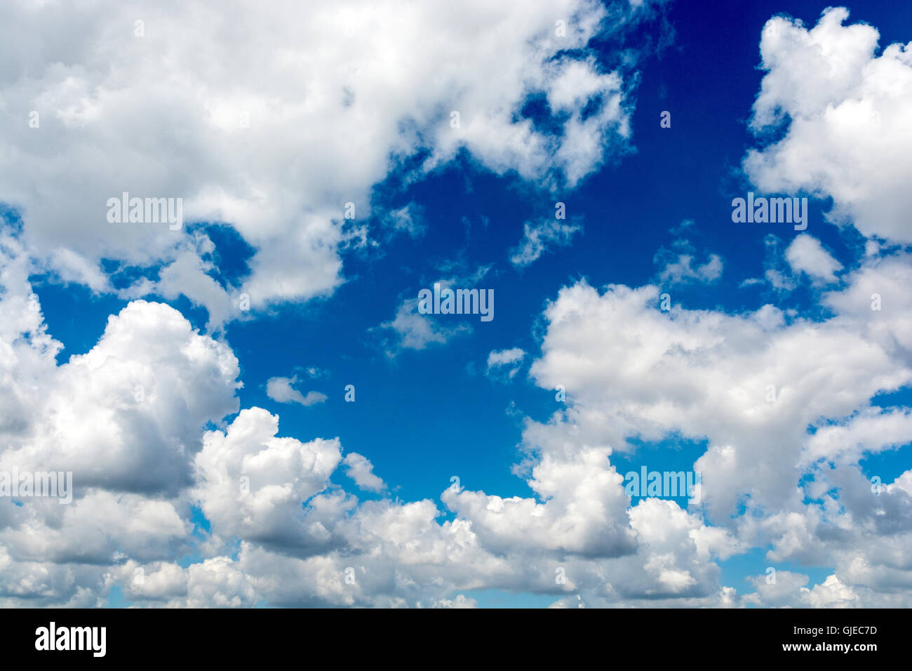 Fluffy white clouds and blue sky Stock Photo - Alamy