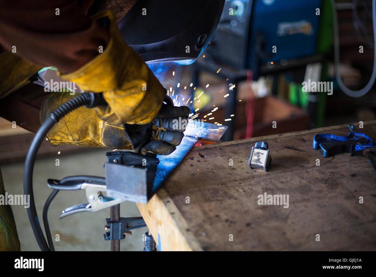 Welder welding steel base for new stool Stock Photo - Alamy