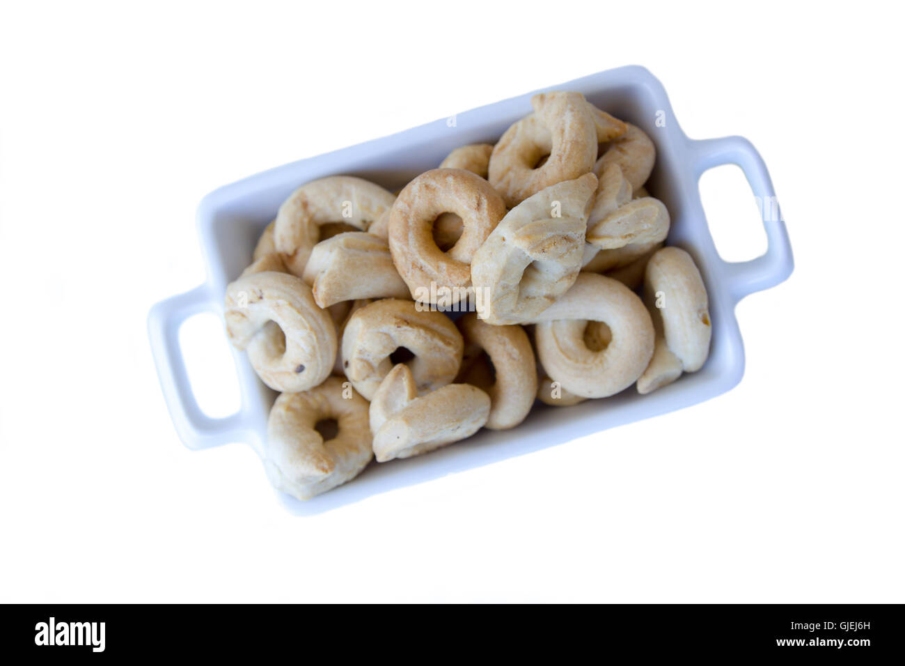 Bagels on a small ceramic tray on a white background seen from above ...