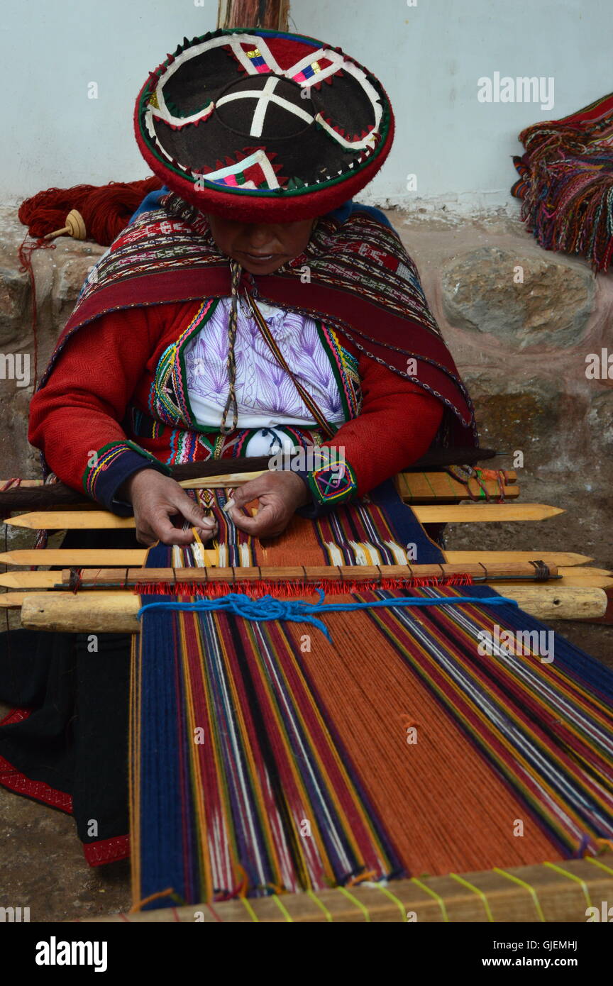 A Peruvian woman knits with a great variety of threads and colors with ...