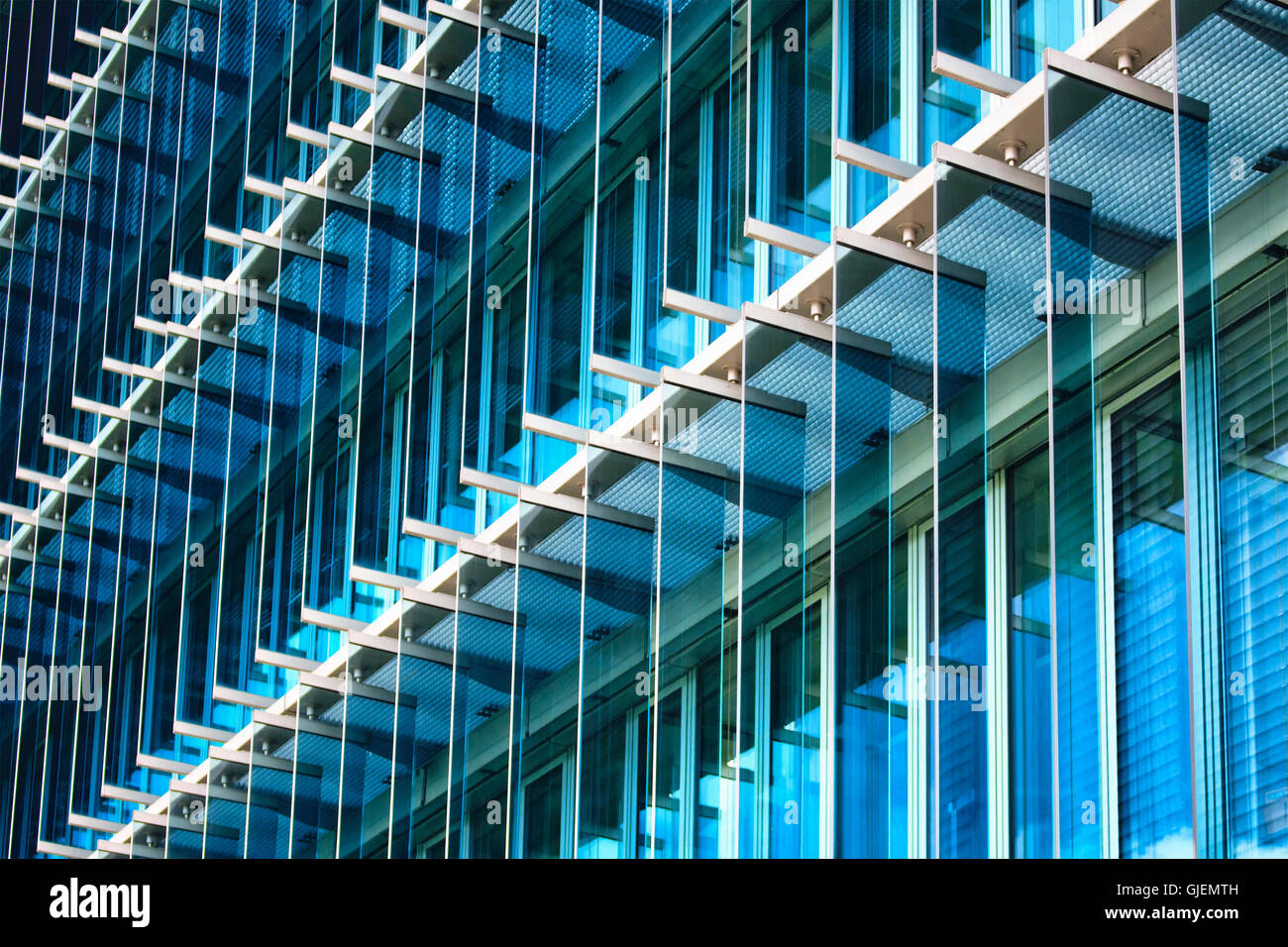 Close up view of facade of a modern architecture with blue glass panels ...