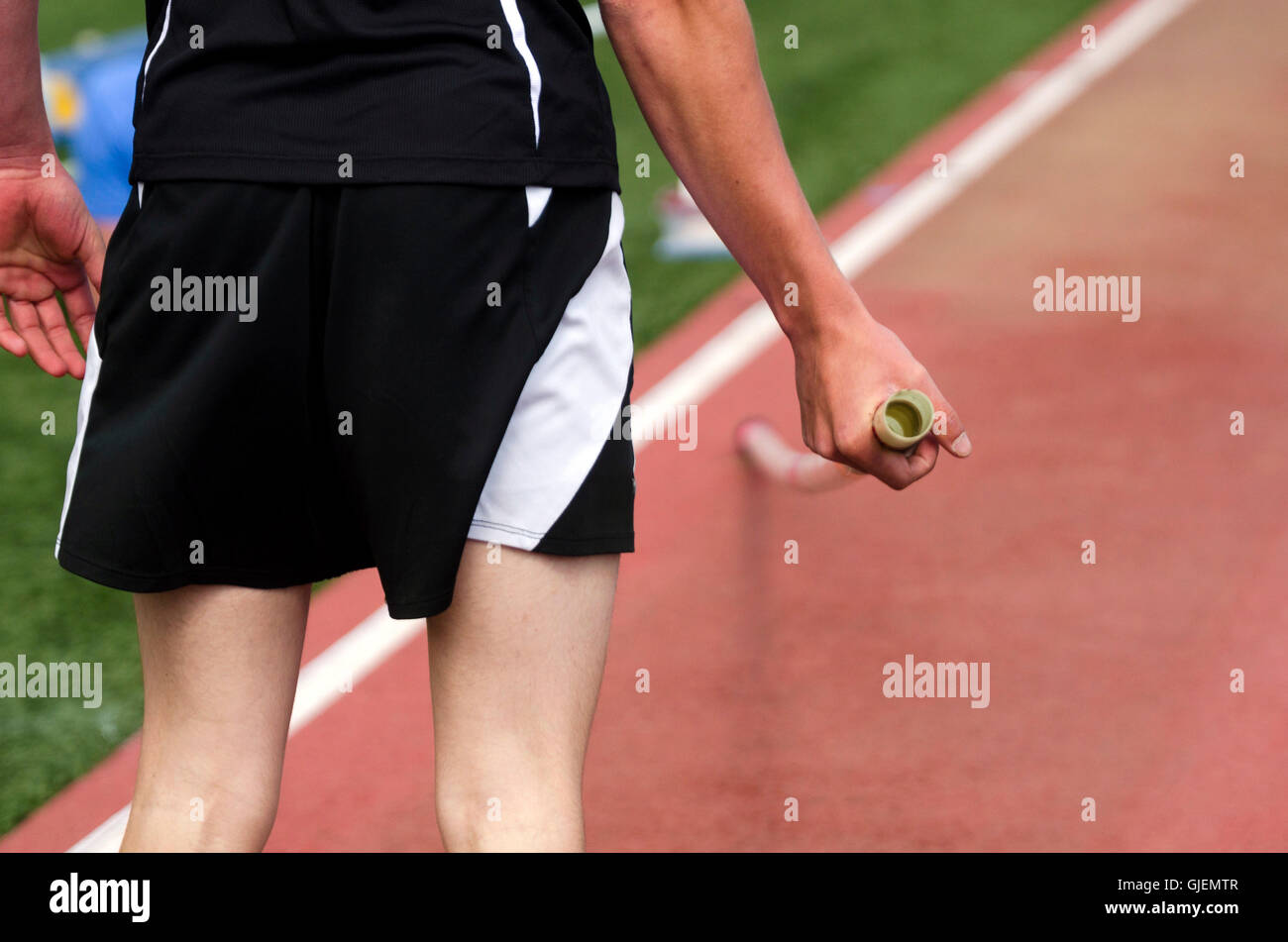 Pole vaulter holding pole Stock Photo - Alamy