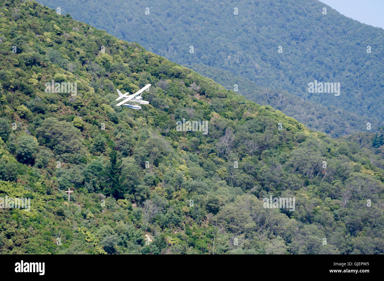 Float Plane in front of forest covered hillside, Picton, Marlborough ...