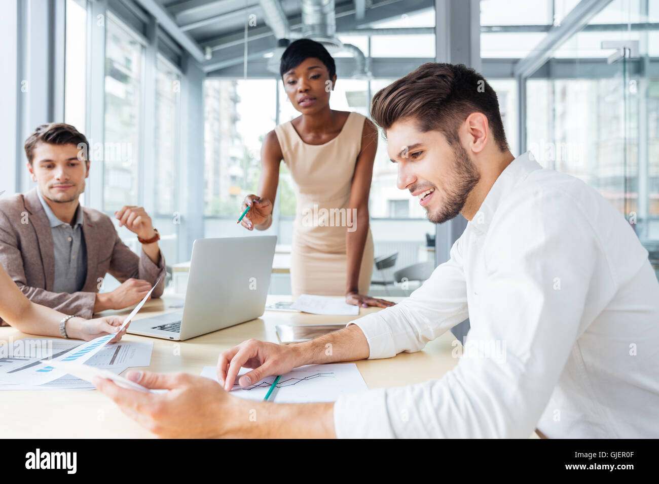 Group of creative young people making new project together in ...