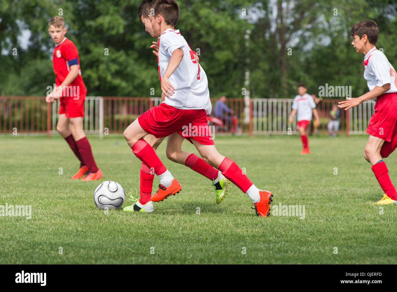 boys kicking football on the sports field Stock Photo - Alamy