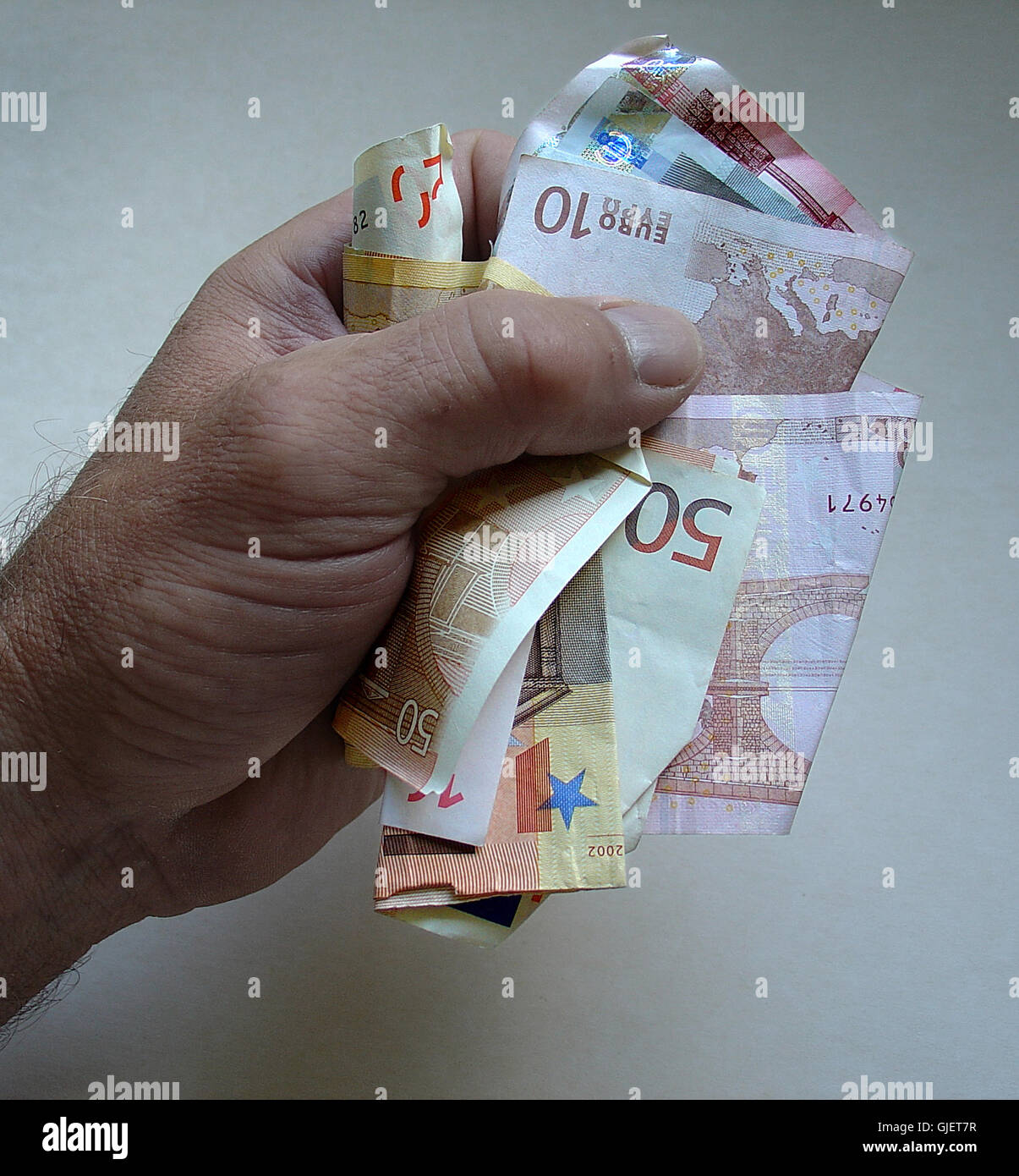 handful of money Stock Photo - Alamy