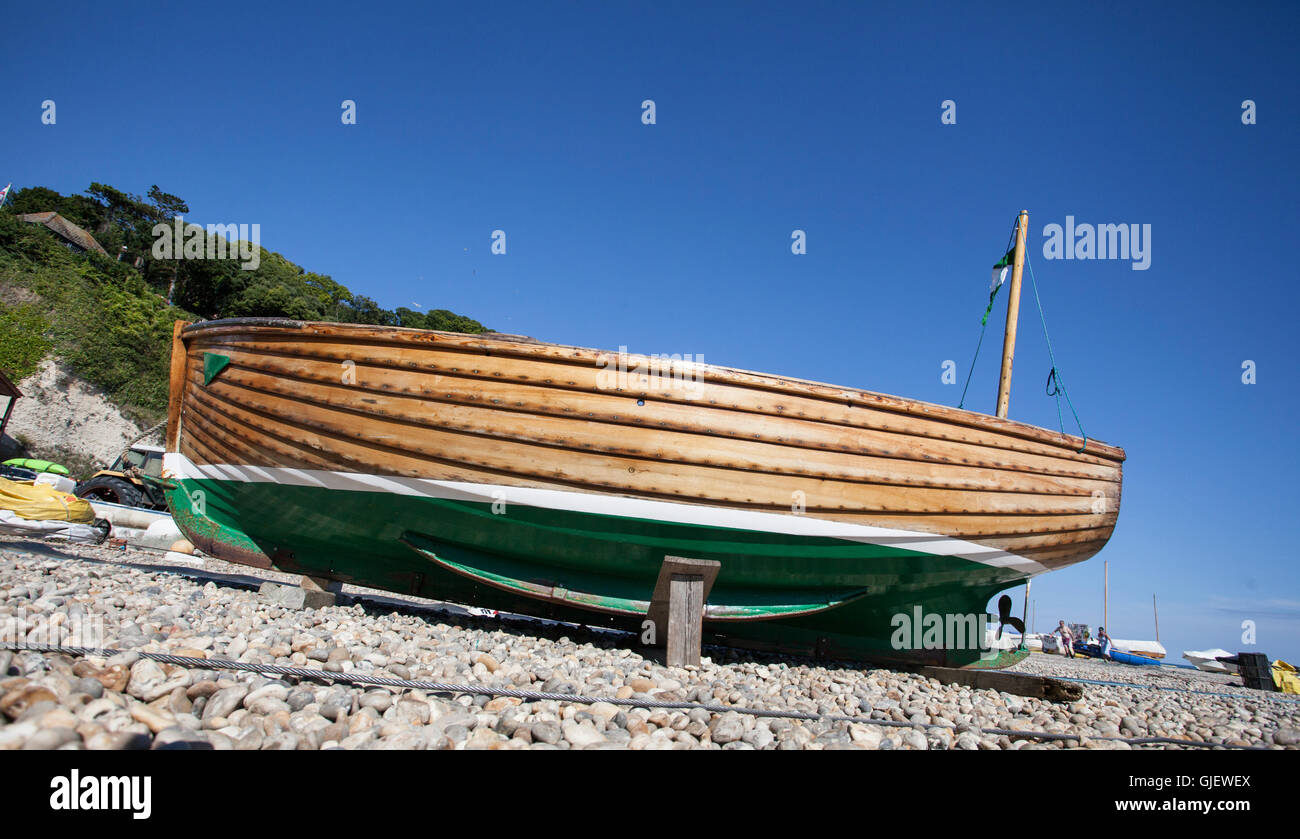 clinker built boat on seashore of pebbles Beer Devon Stock Photo - Alamy