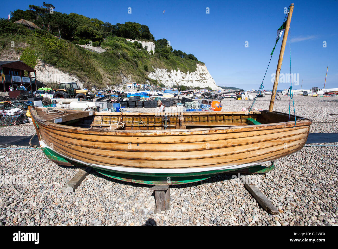 clinker built boat on seashore of pebbles Beer Devon Stock Photo - Alamy