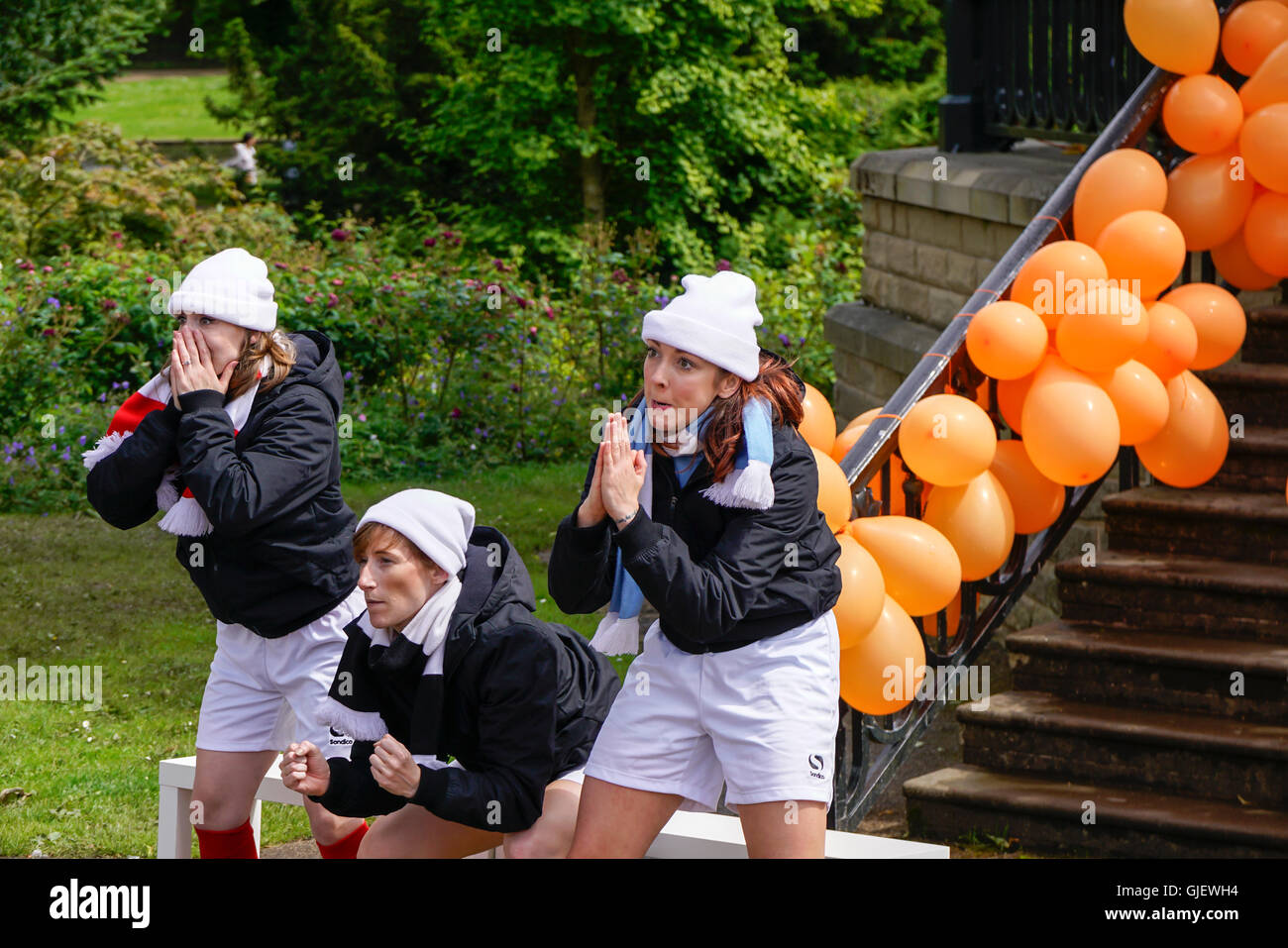Group of girls performing dance routine dressed in football kits in ...