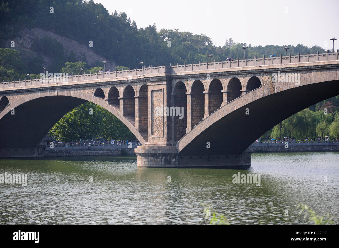 The stone Longmen bridge over the Yi River at Longmen Grottoes in ...