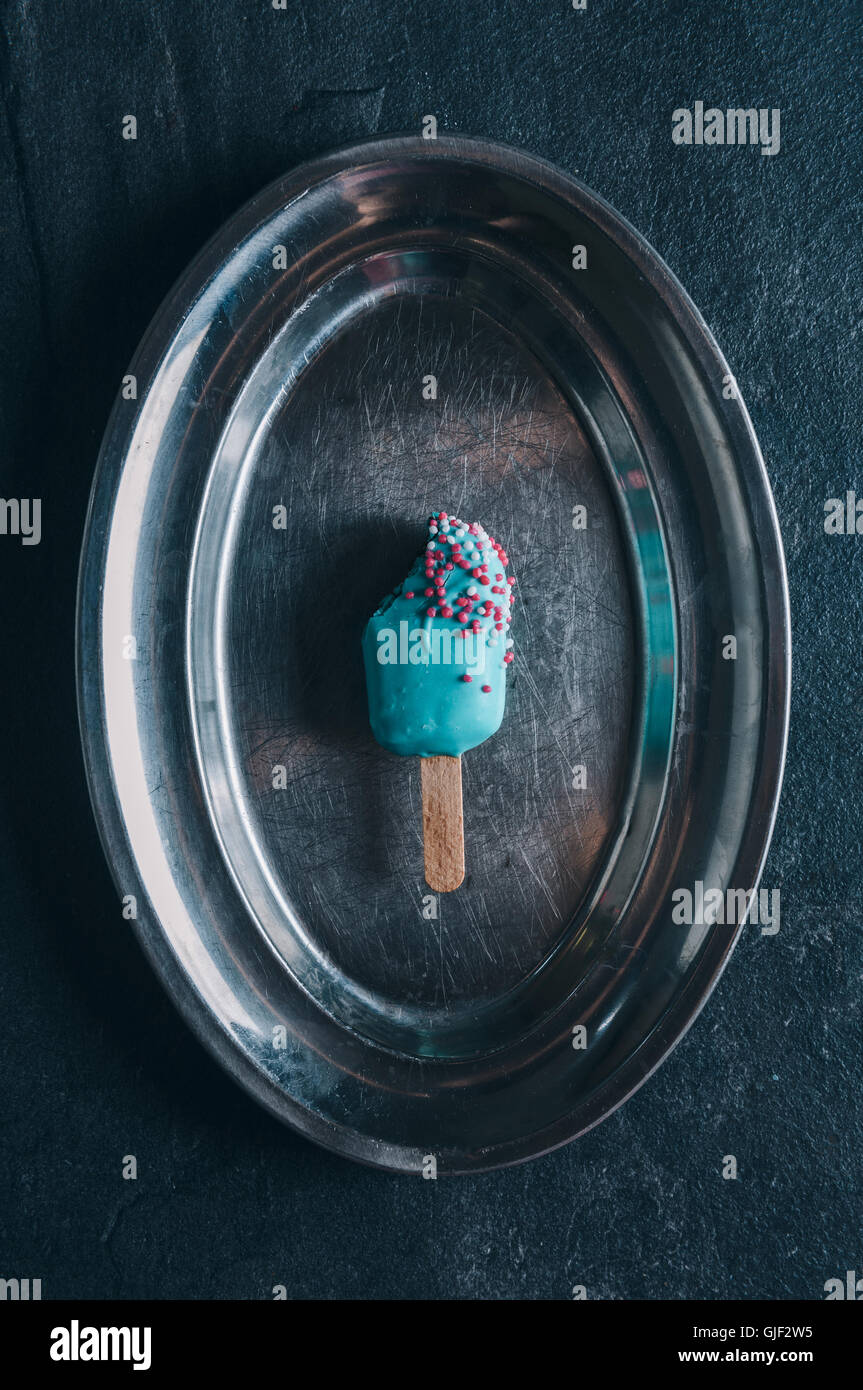 Single cake pop with ice cream ship in the plate Stock Photo - Alamy
