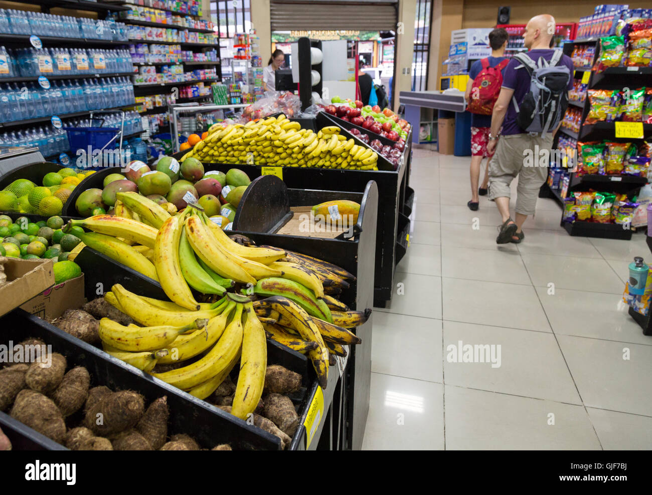 Tourists shopping in a local supermarket interior, La Fortuna, Alajuela ...