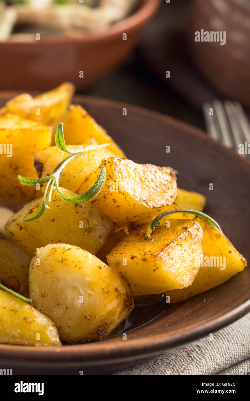 Baked potato with rosemary on plate vertical Stock Photo - Alamy