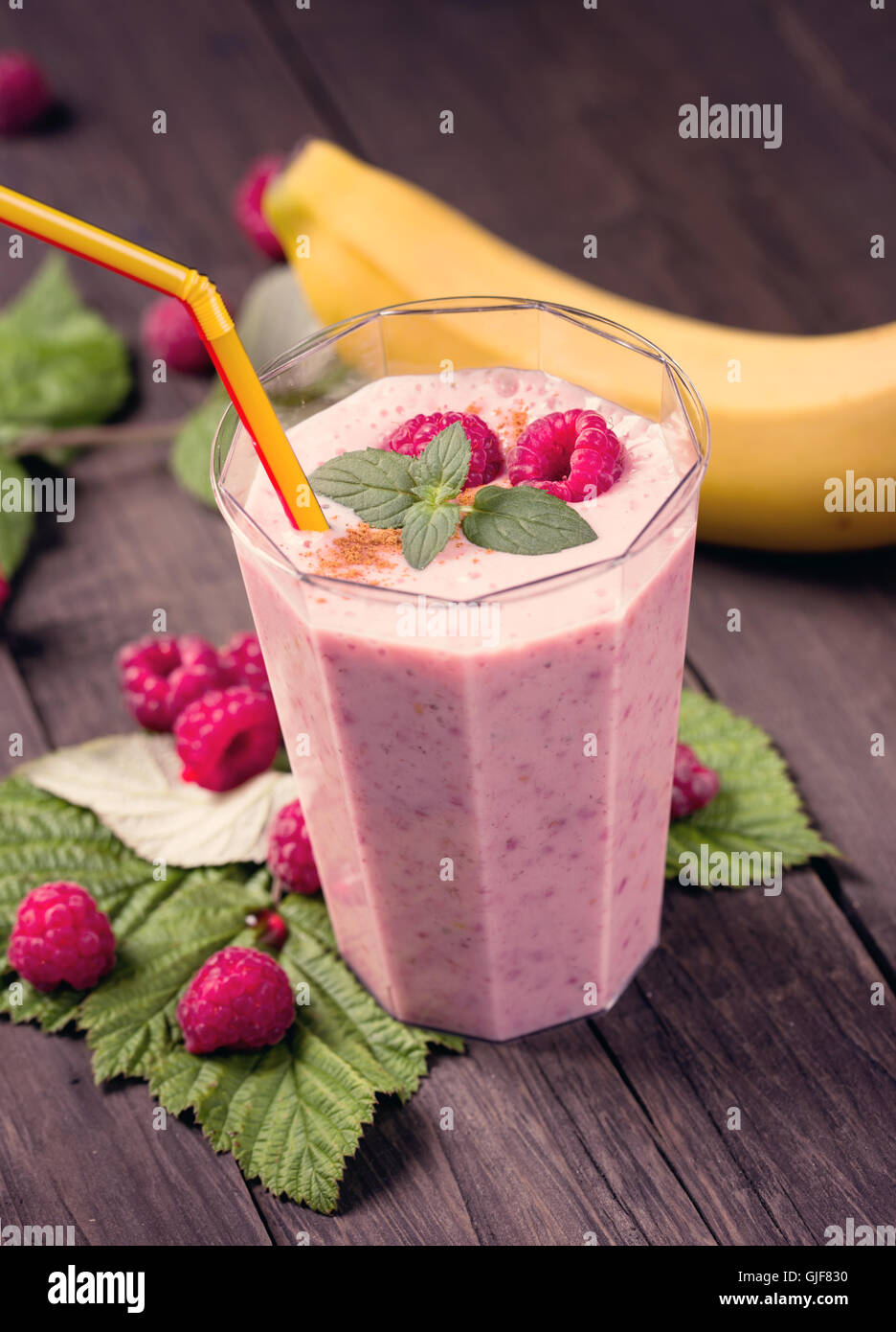 Banana raspberry smoothie on table Stock Photo - Alamy