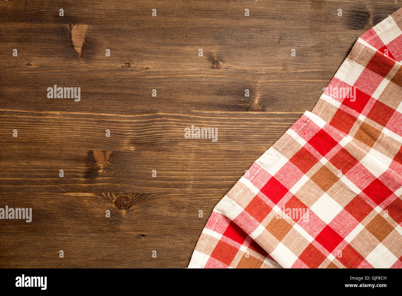 Checkered napkin at right bottom corner of wooden background Stock ...