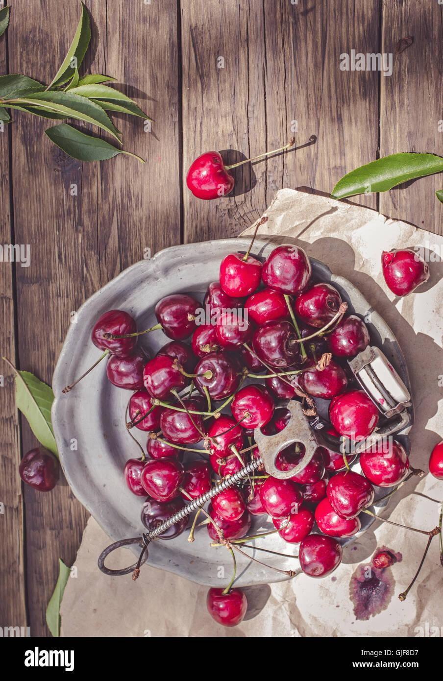 Cherries and old stone remover above Stock Photo - Alamy