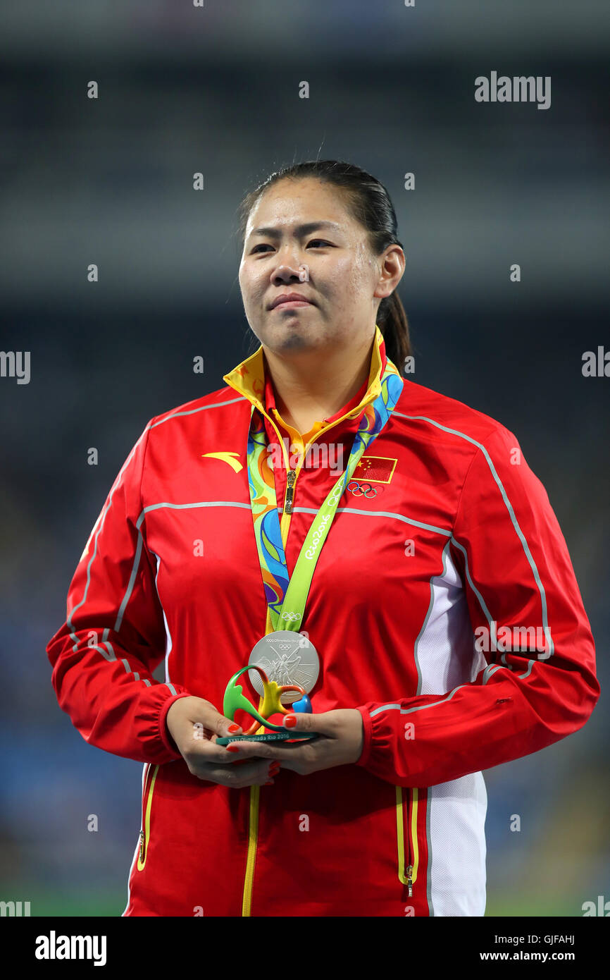 China's Zhang Wenxiu is presented with the silver medal for the Women's ...