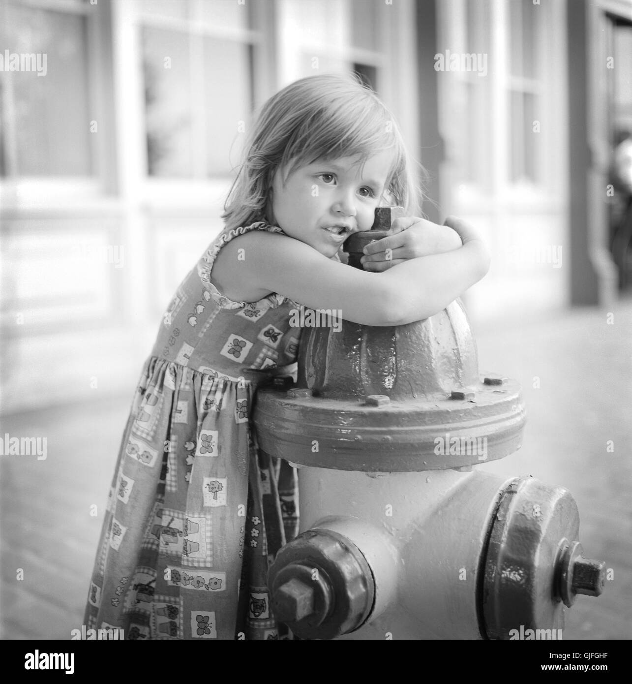 Four year old girl hugs a fire hydrant Stock Photo - Alamy