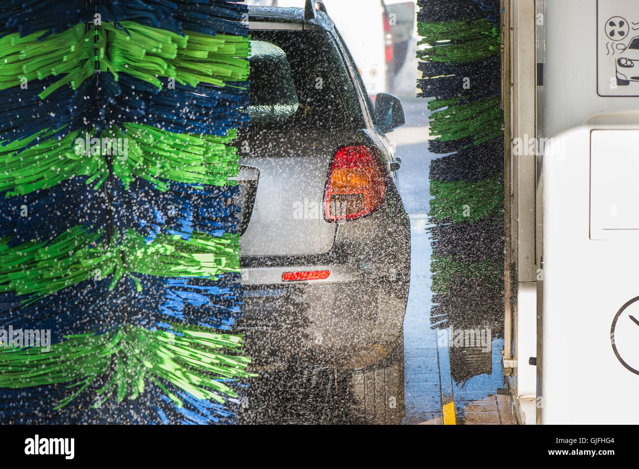 Grey car during washing process Stock Photo - Alamy