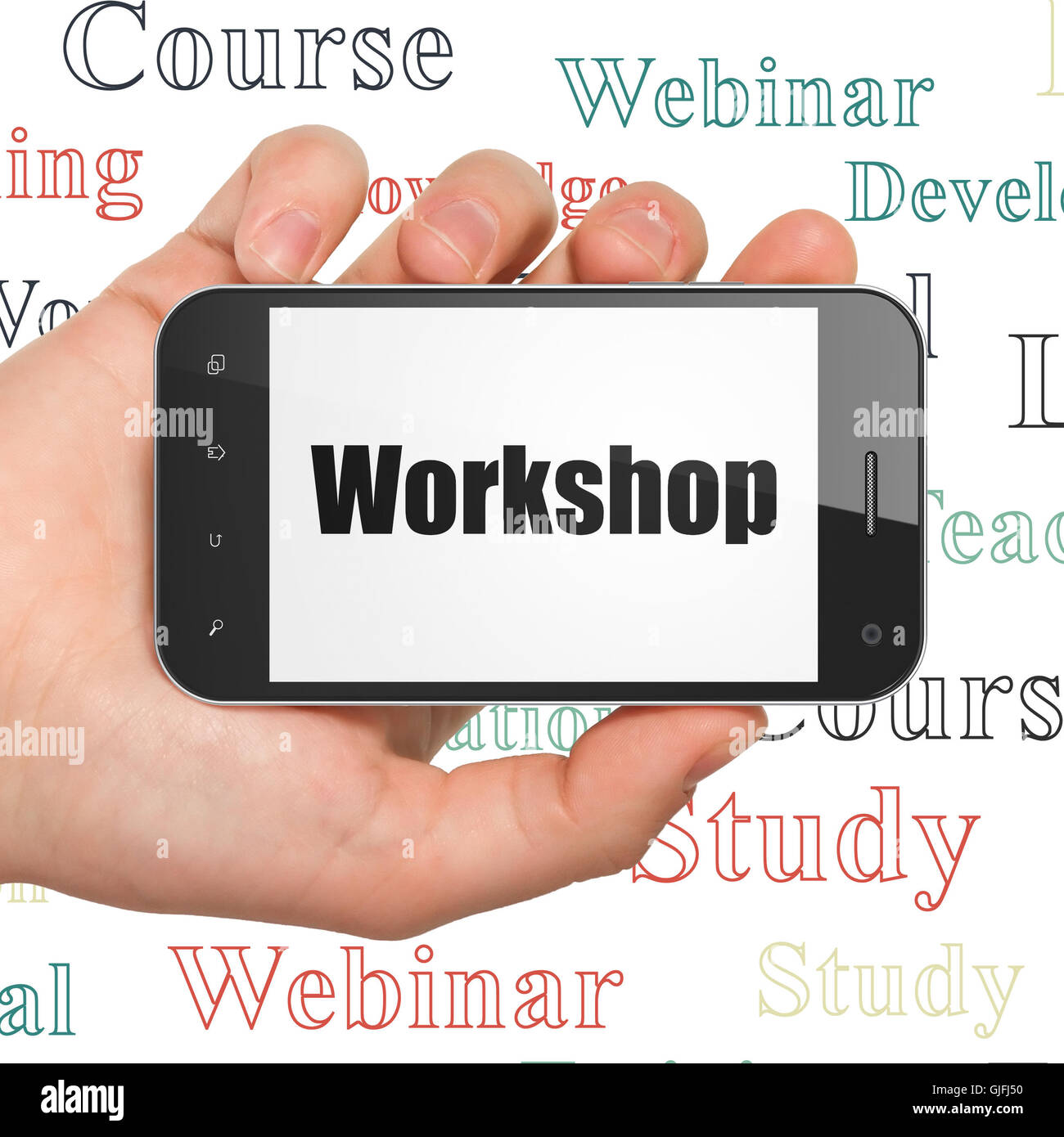 Learning concept: Hand Holding Smartphone with Workshop on display ...