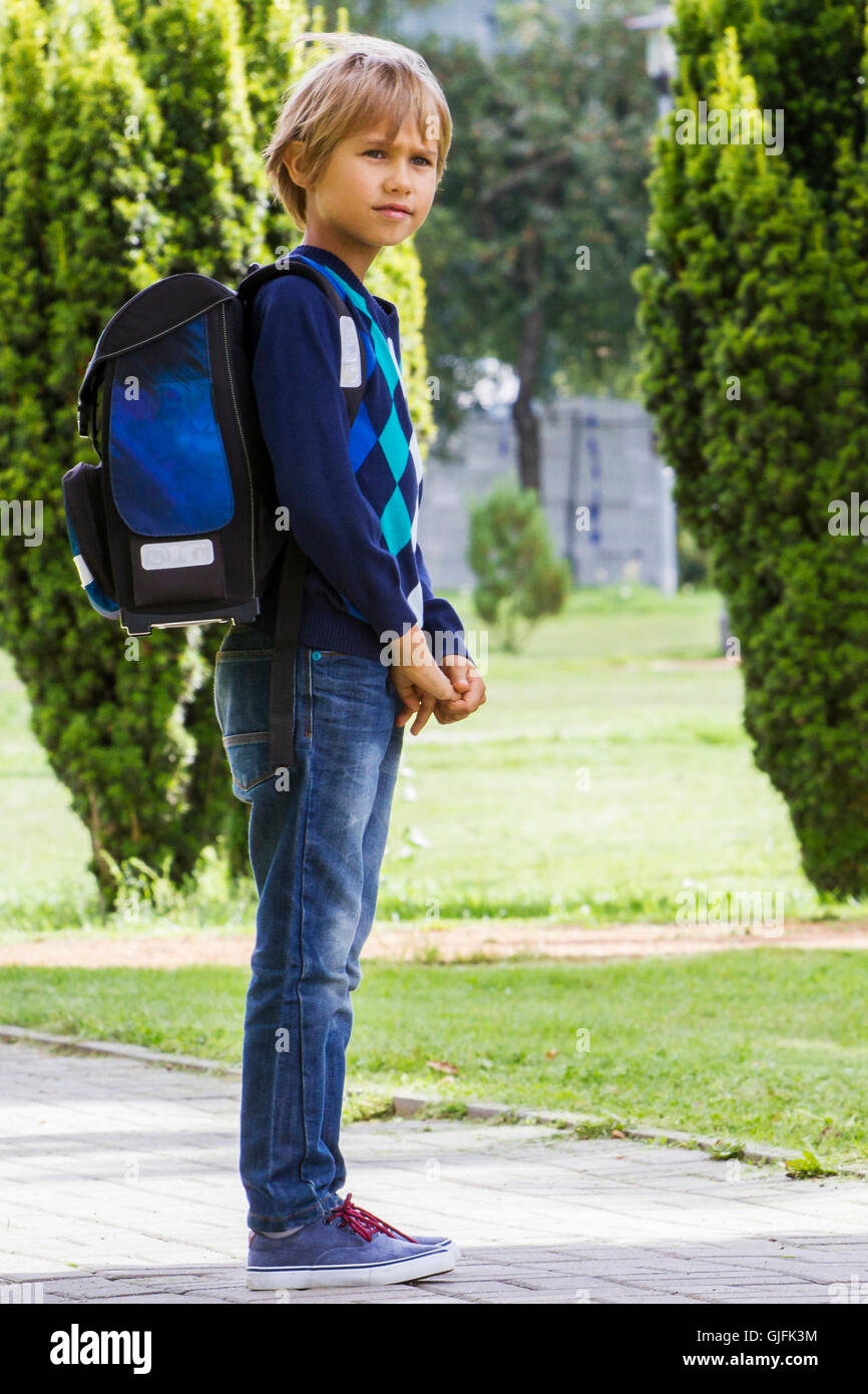 Schoolboy with books and a backpack ready go to school. Outdoor Stock ...