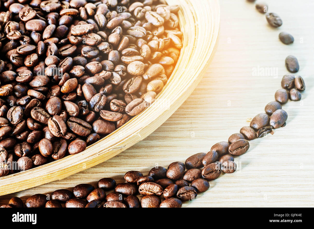 Coffee beans roasted in a wood plate on the table Stock Photo - Alamy