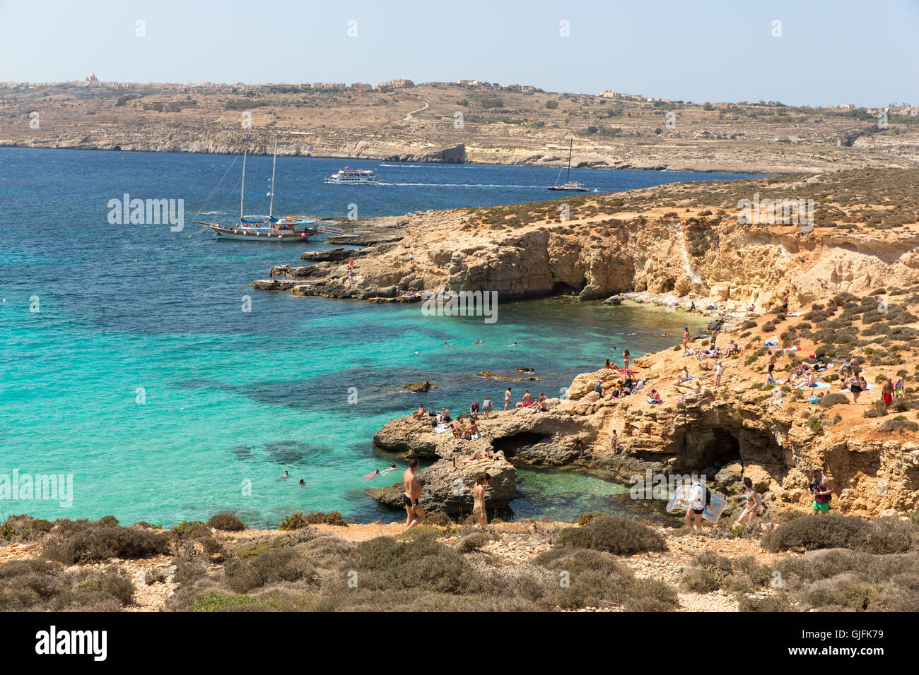 The crystal clear waters in a rocky bay on the Maltese Island of Comino ...