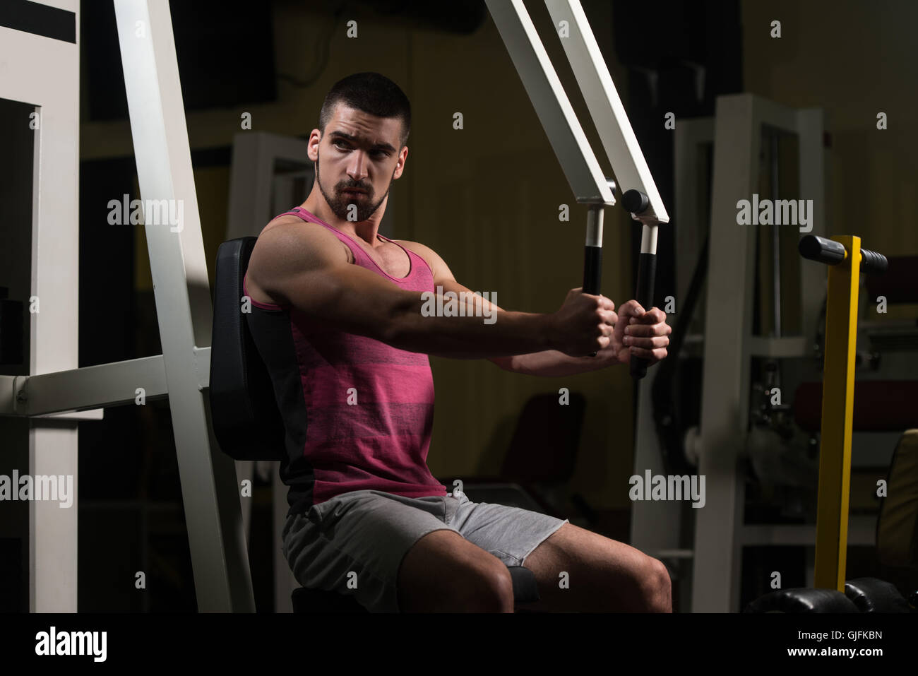 Young Bodybuilder Doing Heavy Weight Exercise For Chest On Machine ...
