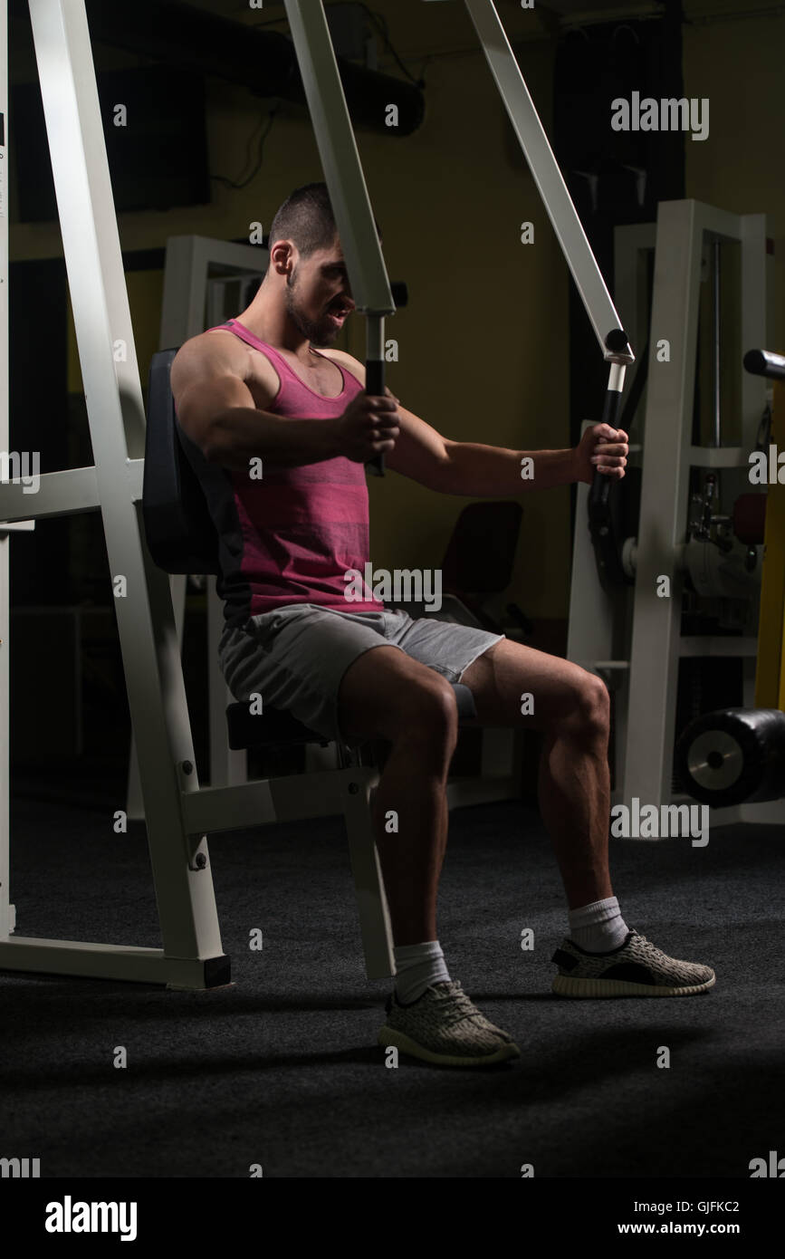 Young Bodybuilder Doing Heavy Weight Exercise For Chest On Machine ...