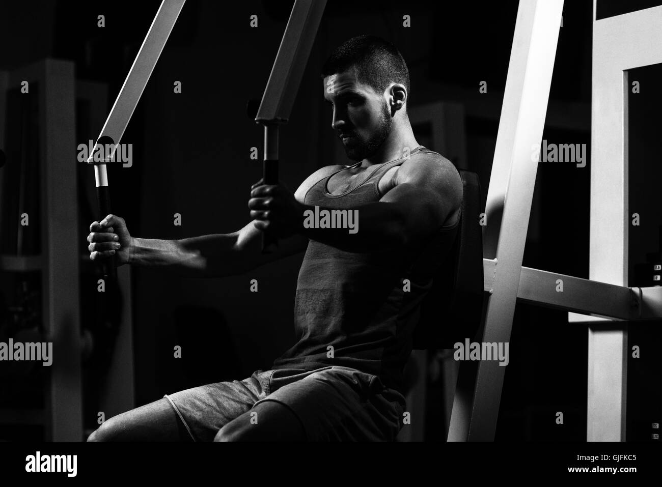 Young Bodybuilder Doing Heavy Weight Exercise For Chest On Machine ...