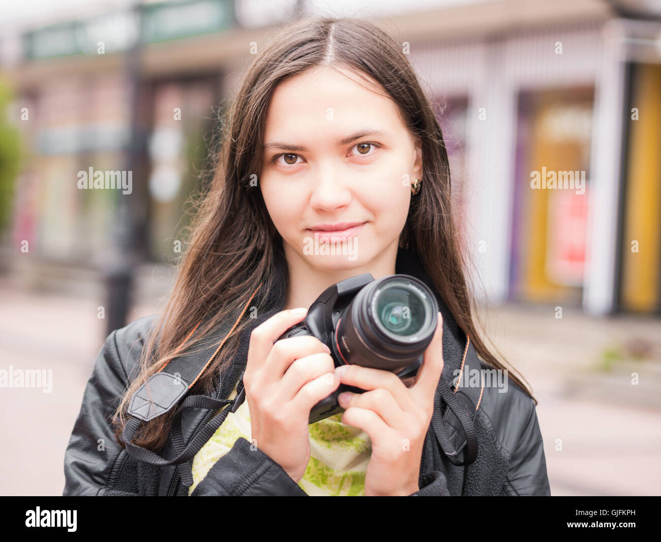 Woman with dslr camera on city street Stock Photo - Alamy