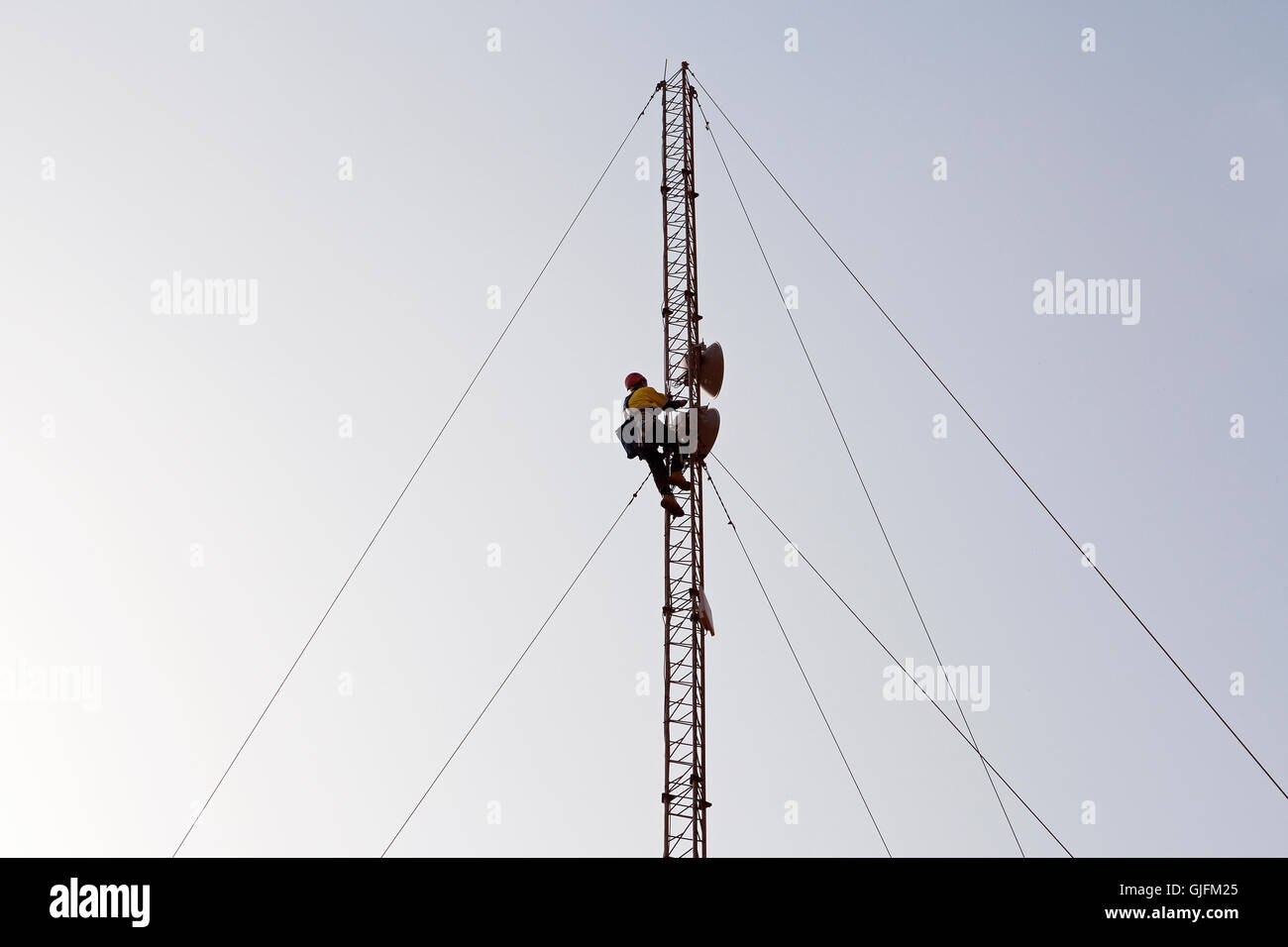 Iron ore mine in Sierra Leone. Telecoms engineer up tower working at ...