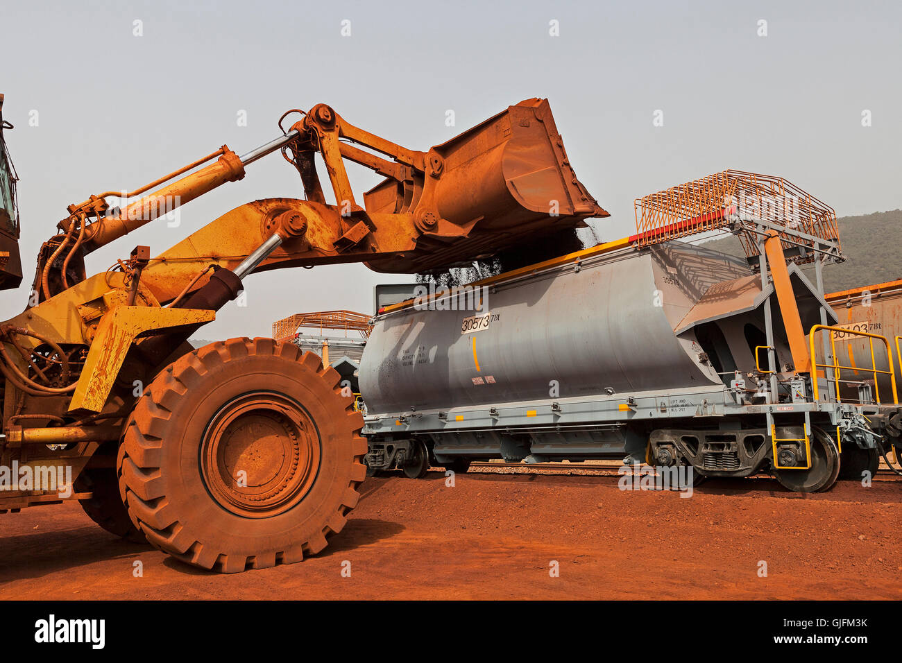 Rail head operations with wagons on trains being loaded with hematite ...