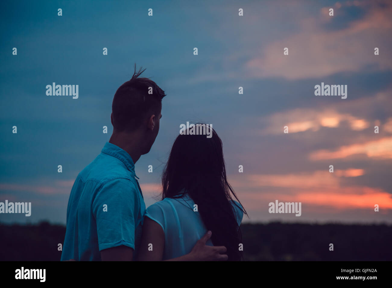 Love story. In love couple walking on sunset background. Happy end ...