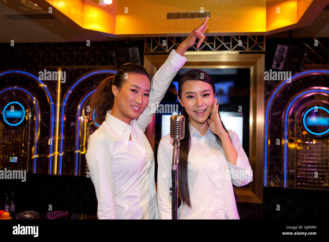 Young woman singing in KTV Stock Photo - Alamy