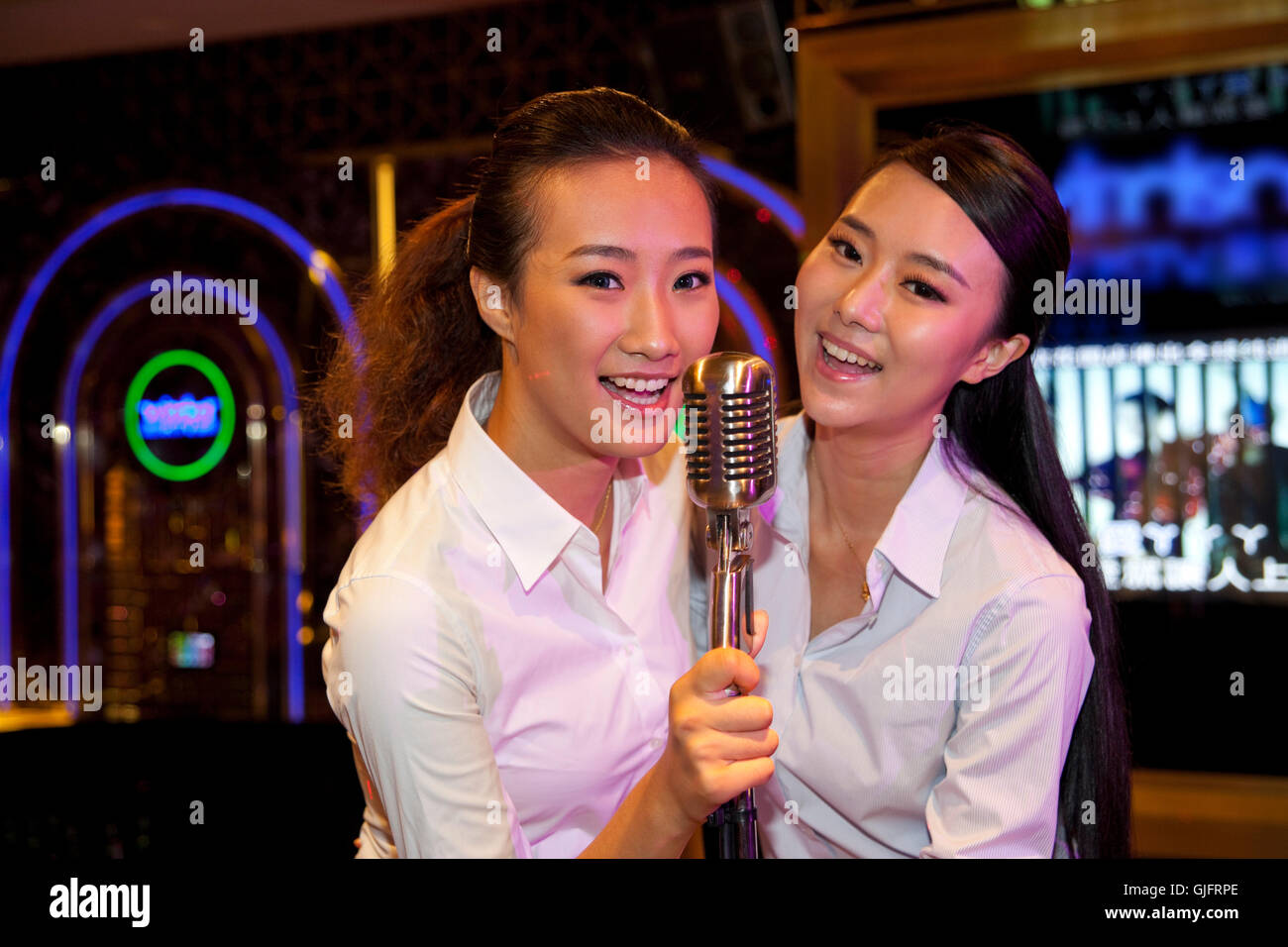 Young woman singing in KTV Stock Photo - Alamy