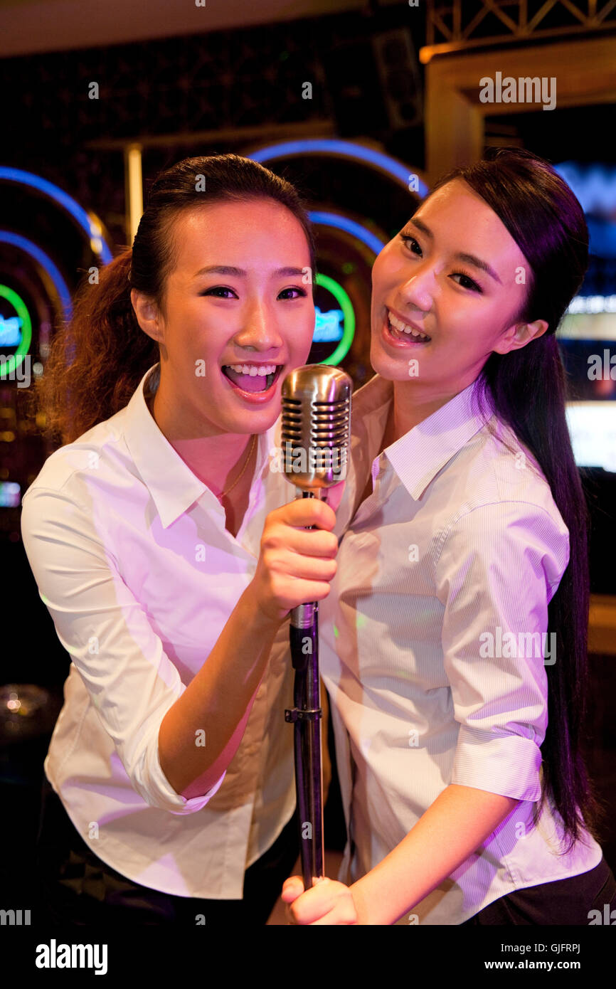 Young woman singing in KTV Stock Photo - Alamy