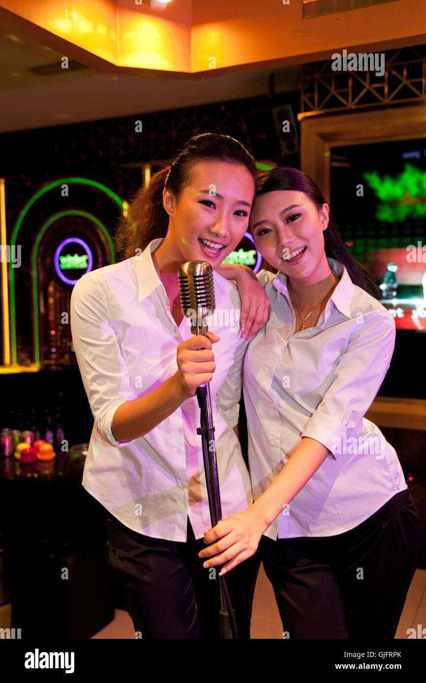 Young woman singing in KTV Stock Photo - Alamy