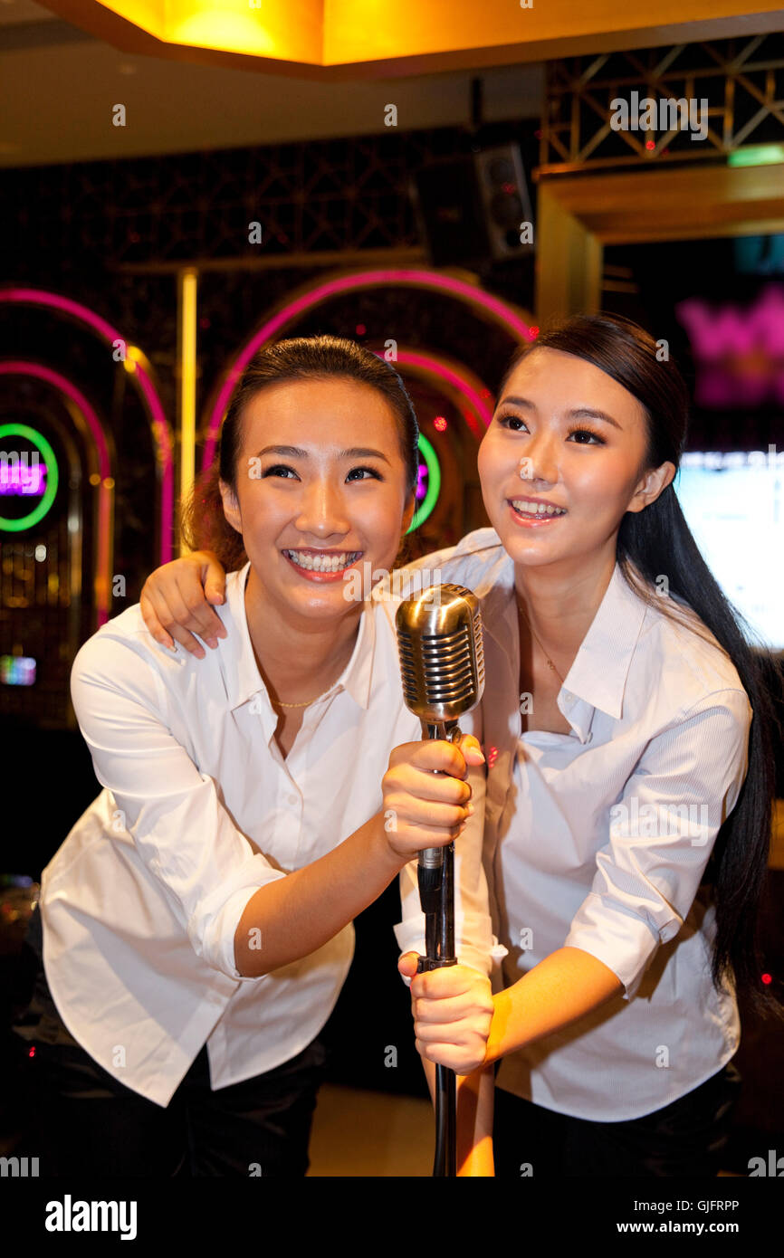 Young woman singing in KTV Stock Photo - Alamy