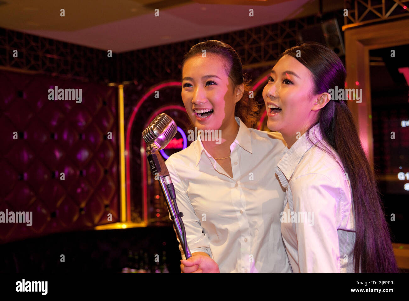 Young woman singing in KTV Stock Photo - Alamy