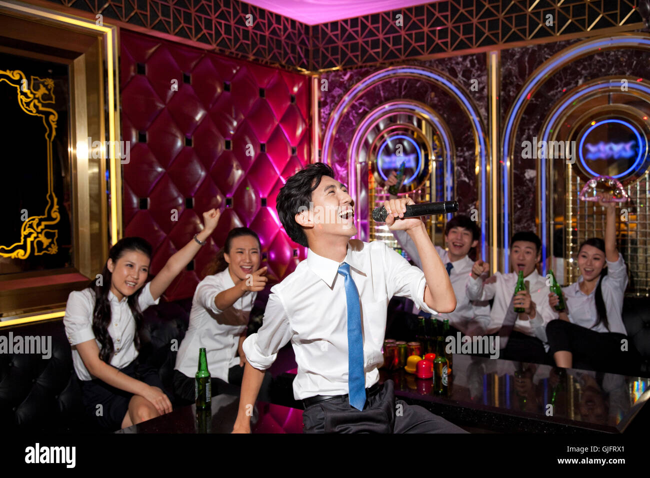 Group of young people gathering in KTV Stock Photo - Alamy